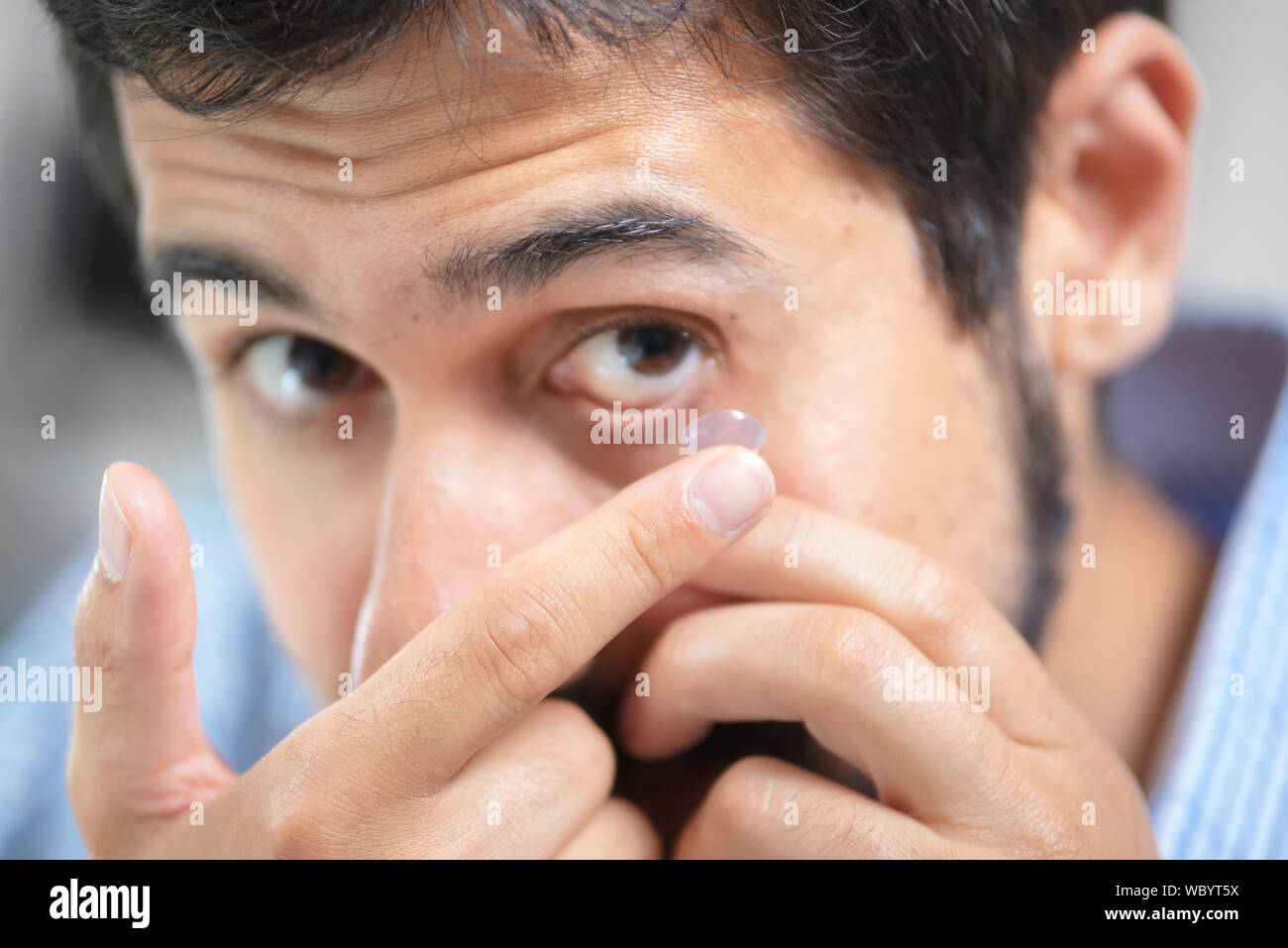 Put on contact lens hi-res stock photography and images - Alamy