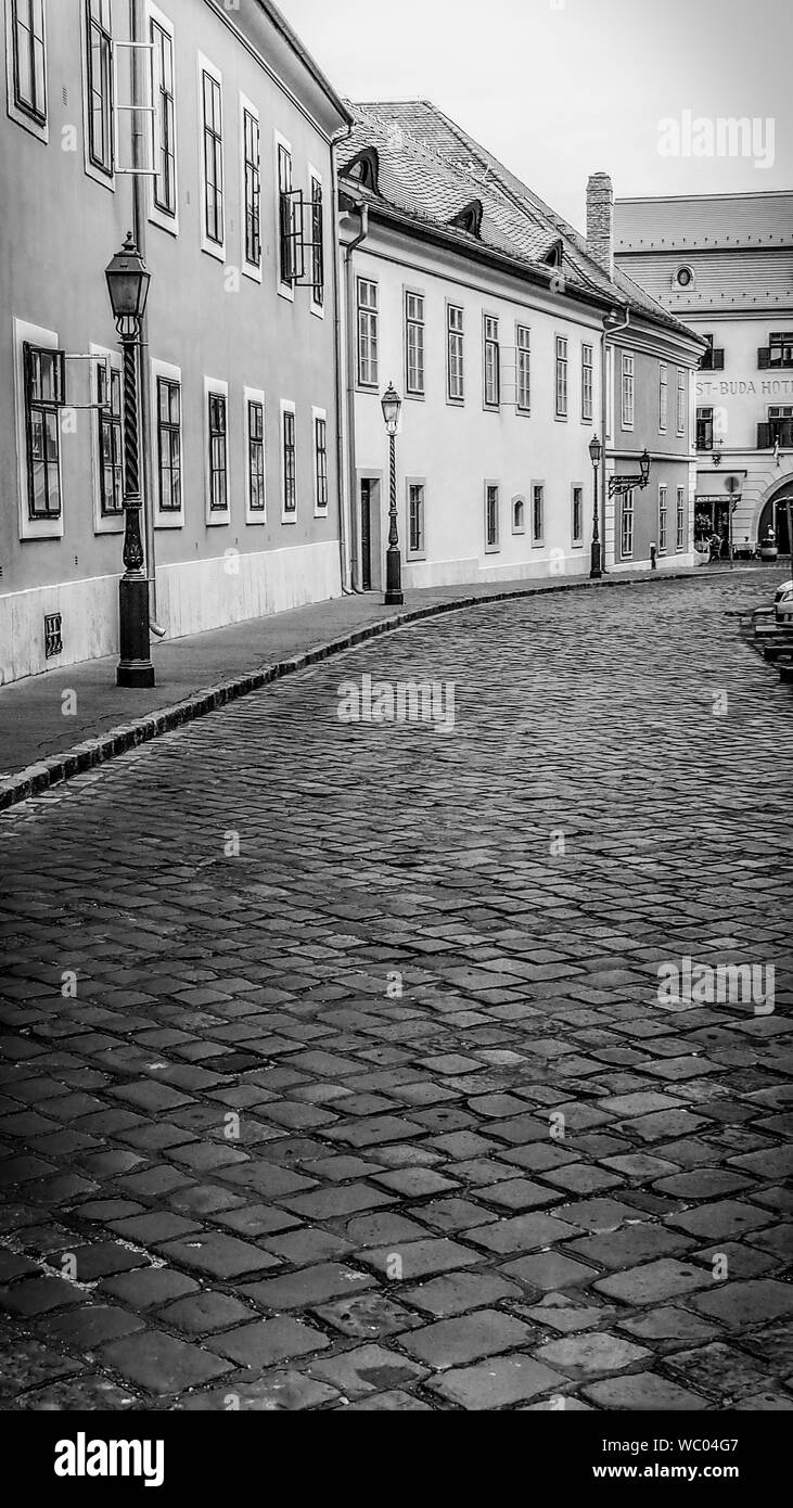 Empty Street By Buildings Stock Photo - Alamy