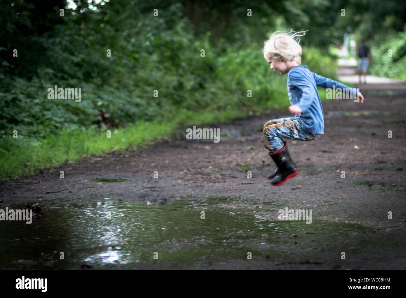Jumping over puddle hi-res stock photography and images - Alamy