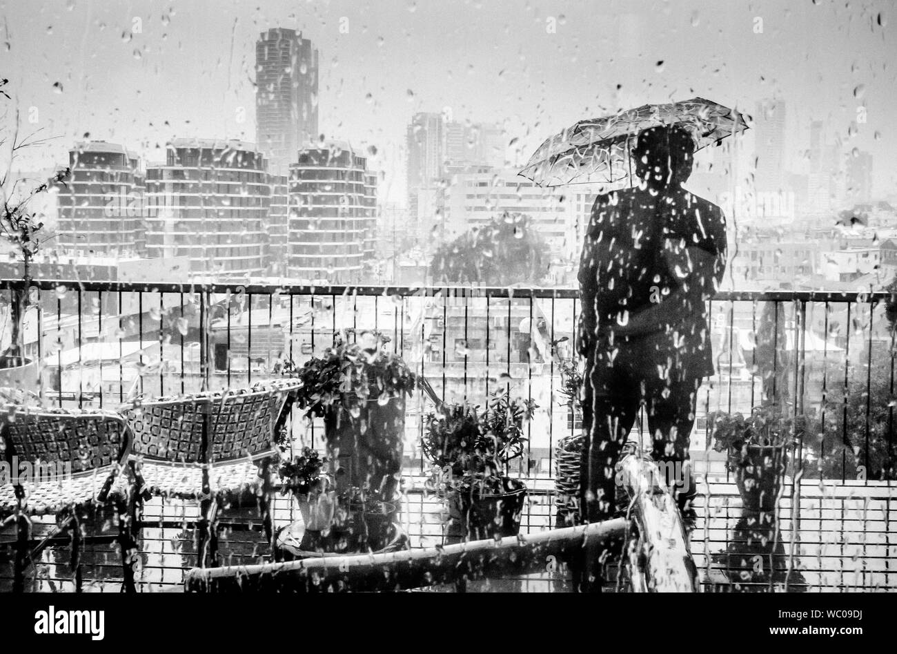 Man Standing In Rain