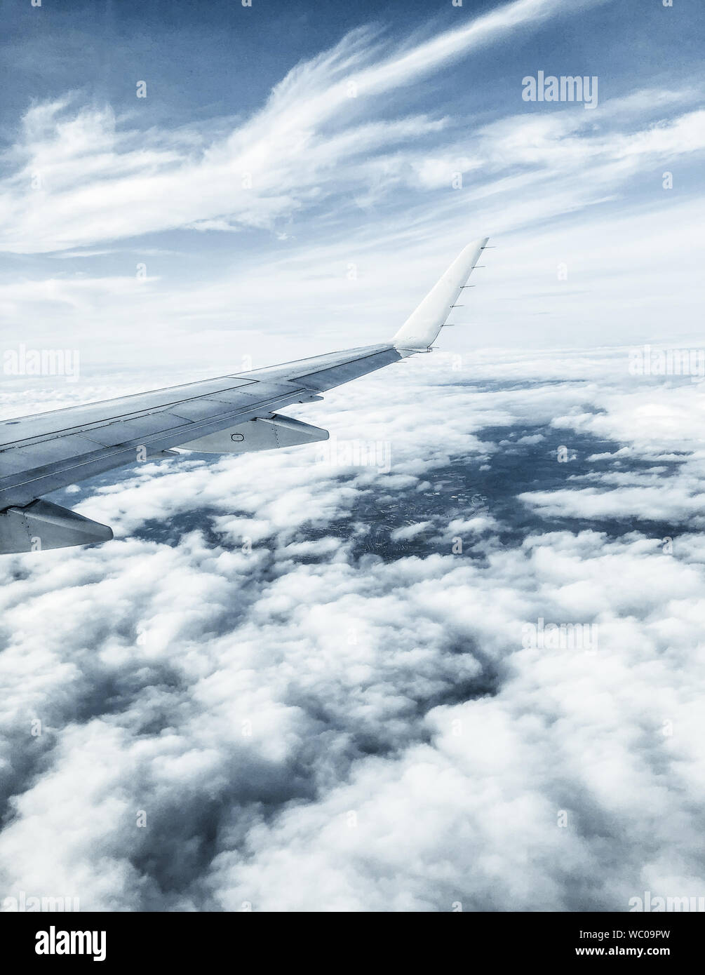 Section of an jet aircraft wing above the clouds from a passanger ...