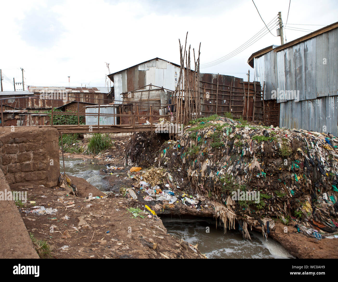 Slum with layers of garbage and filthy water Stock Photo - Alamy