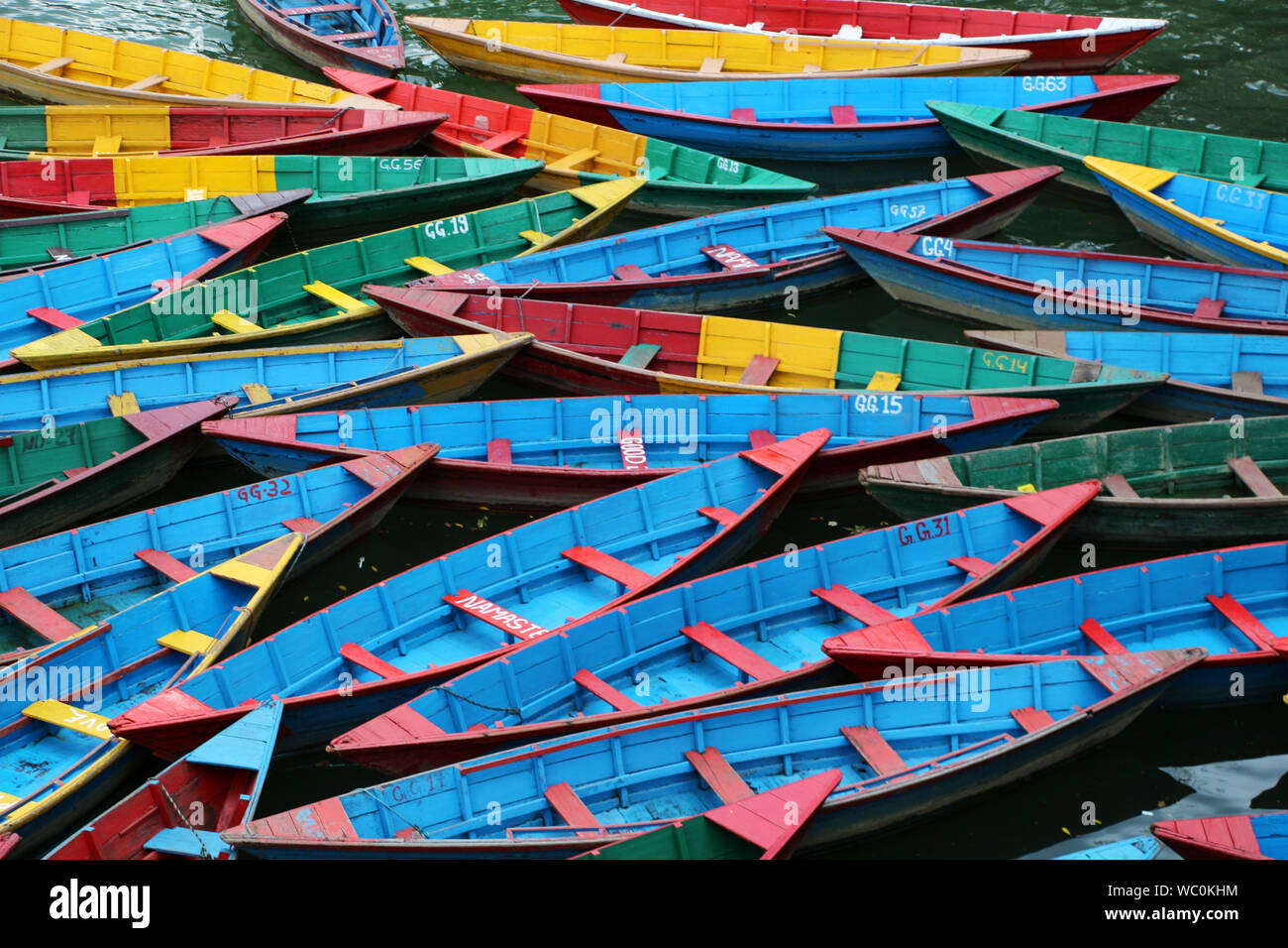 Colorful boats in Nepal on a lake backgrounds Stock Photo - Alamy