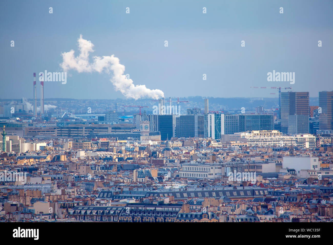 Smoking industrial pipes and Paris panoramic view Stock Photo - Alamy