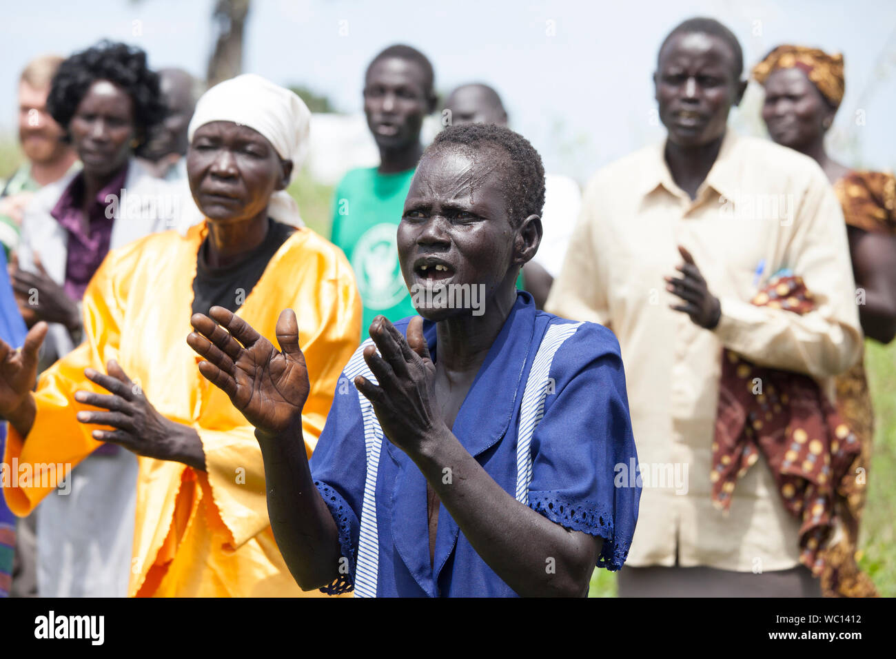 PANWELL, SOUTH SUDAN-NOVEMBER 2, 2013: Unidentified worshippers clap ...