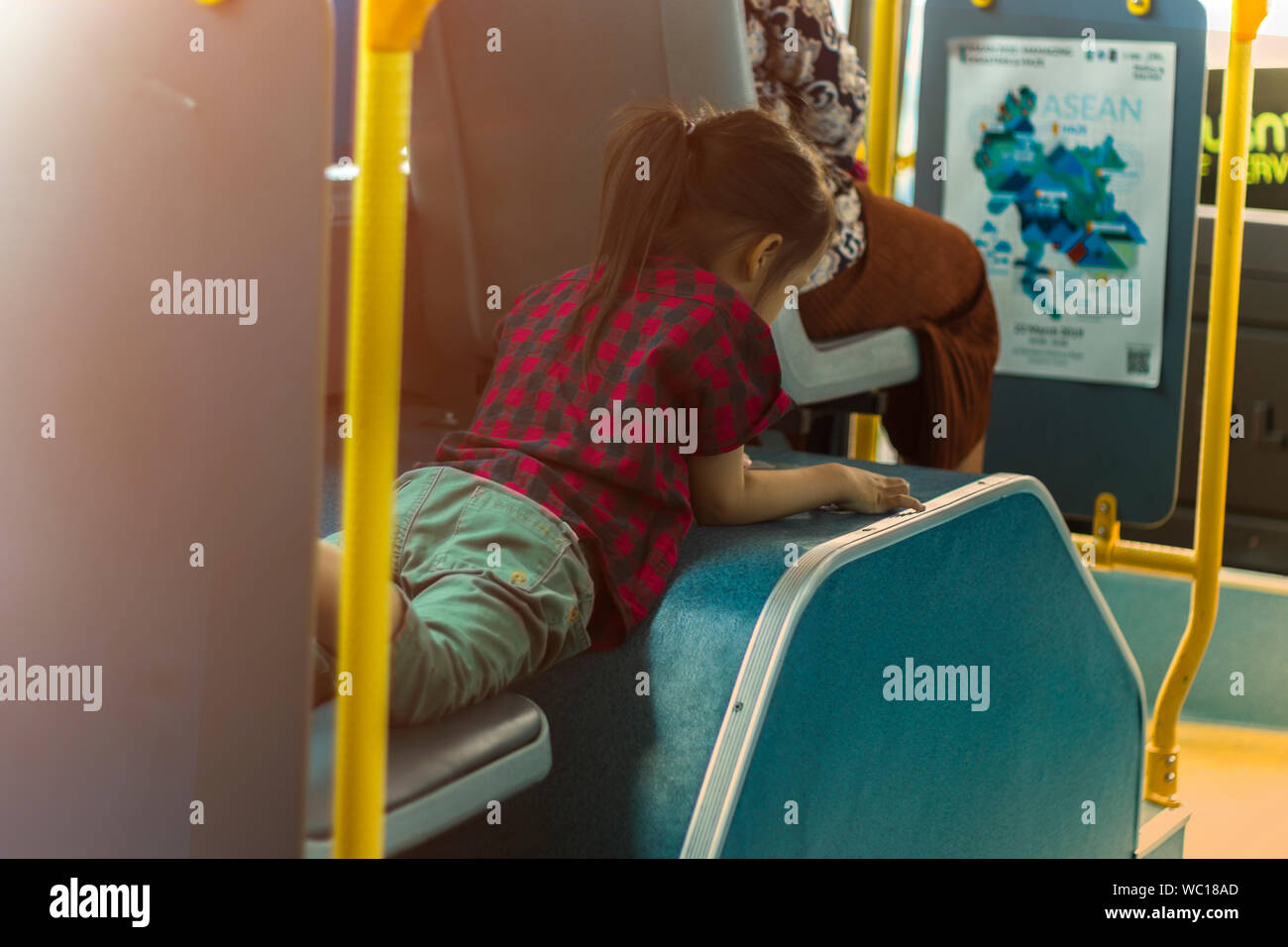 a child lays on the seat in the shaking bus. alone. High resolution ...