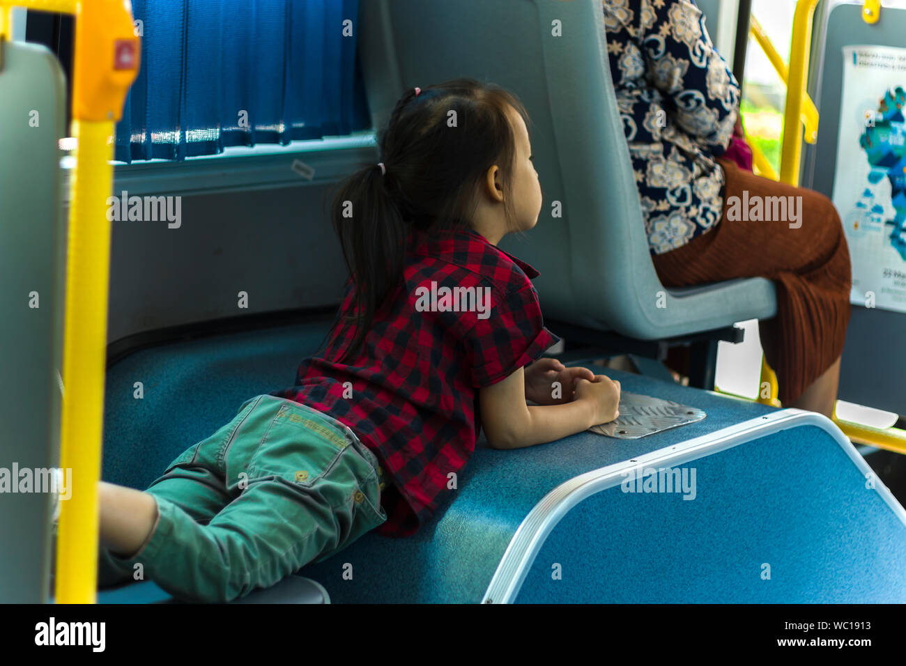 a child lays on the seat in the shaking bus. alone. High resolution ...