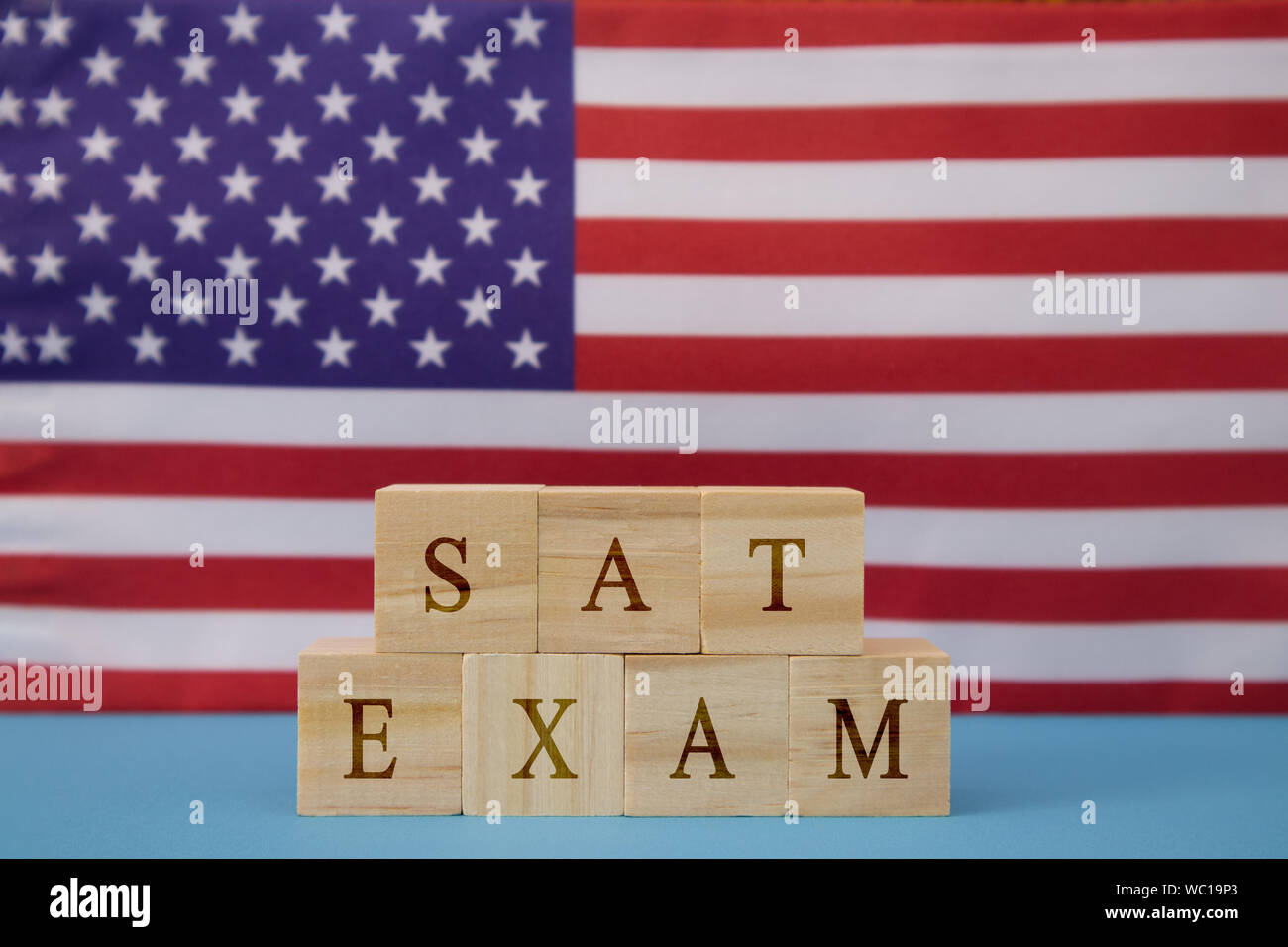 SAT Exam in Wooden block letters on US flag Stock Photo - Alamy