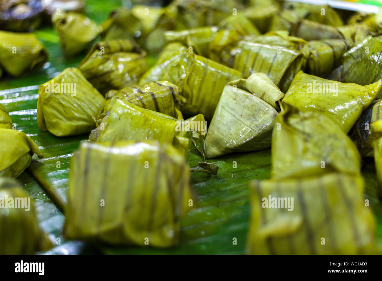 Thai dessert sticky rice, coconut milk and banana wrapped in banana ...