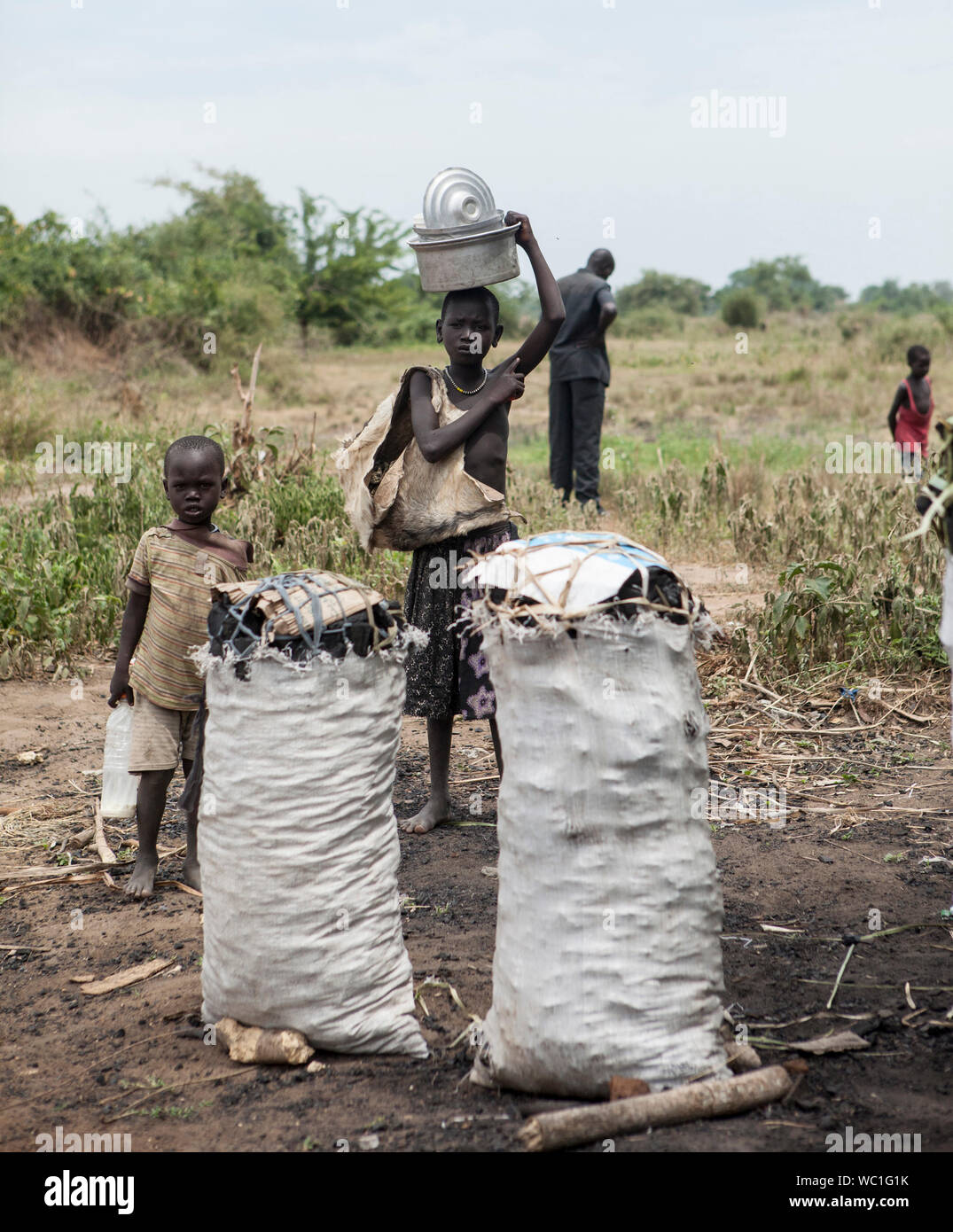 MANGALLA, SOUTH SUDAN-JUNE 22, 2012: Unidentified children sell bags of ...