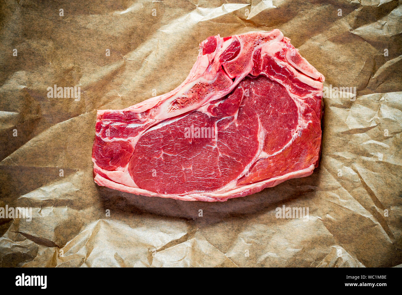 Fresh, huge and appetizing club steak on brown paper Stock Photo - Alamy