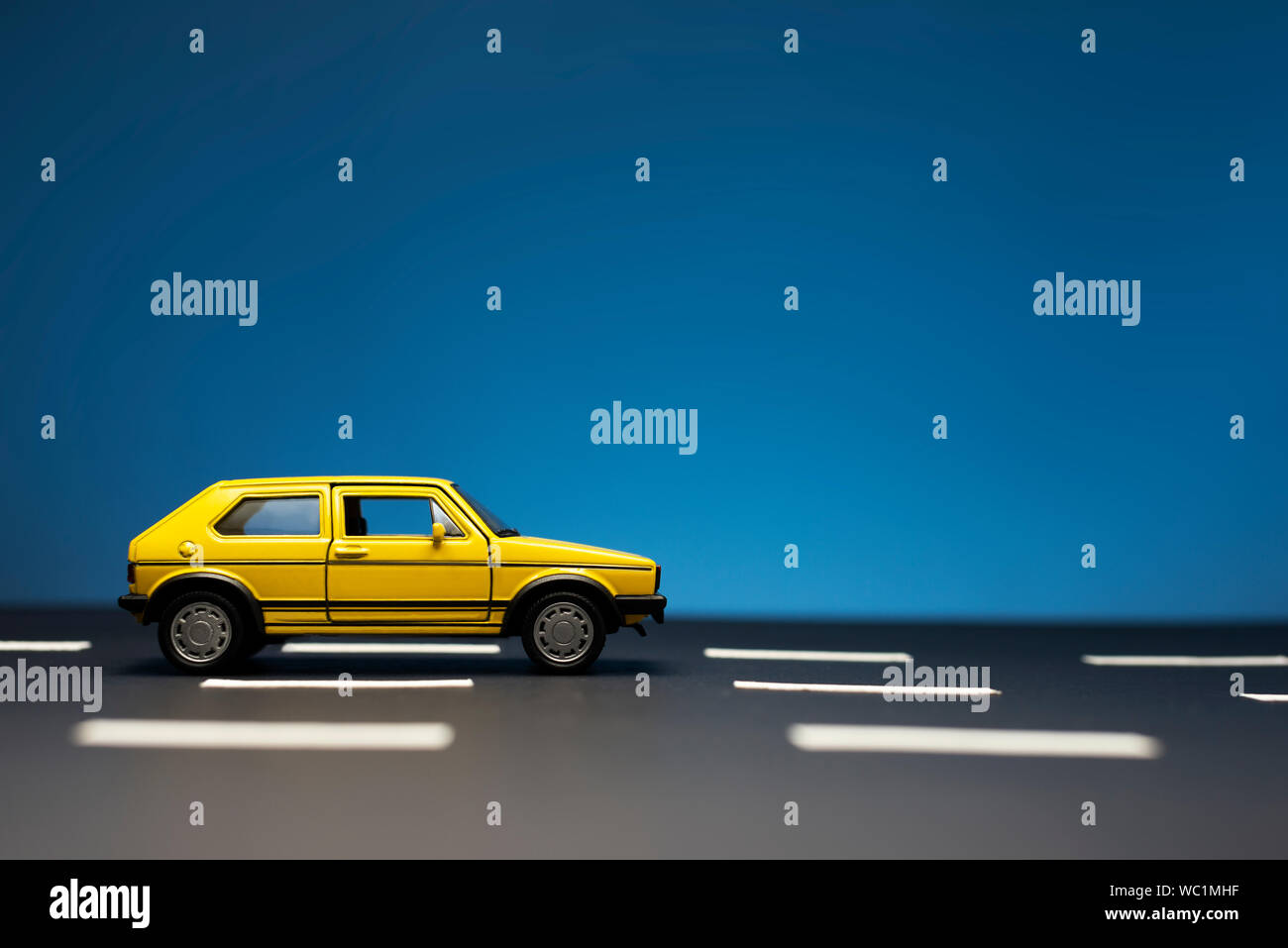 Yellow sedan toy car with two doors on a blue background Stock Photo ...