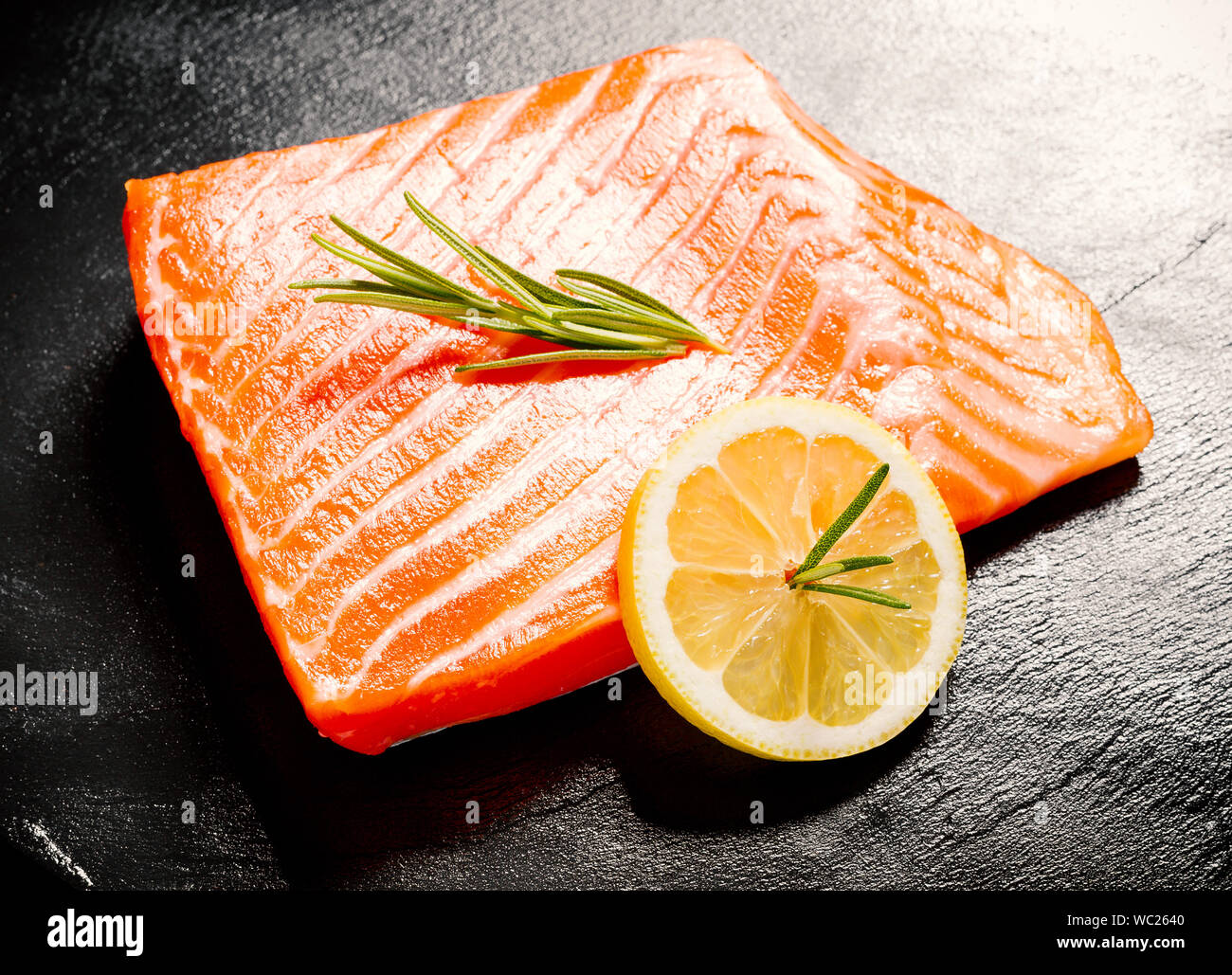 Juicy salmon fillet on black slate plate, top view Stock Photo - Alamy