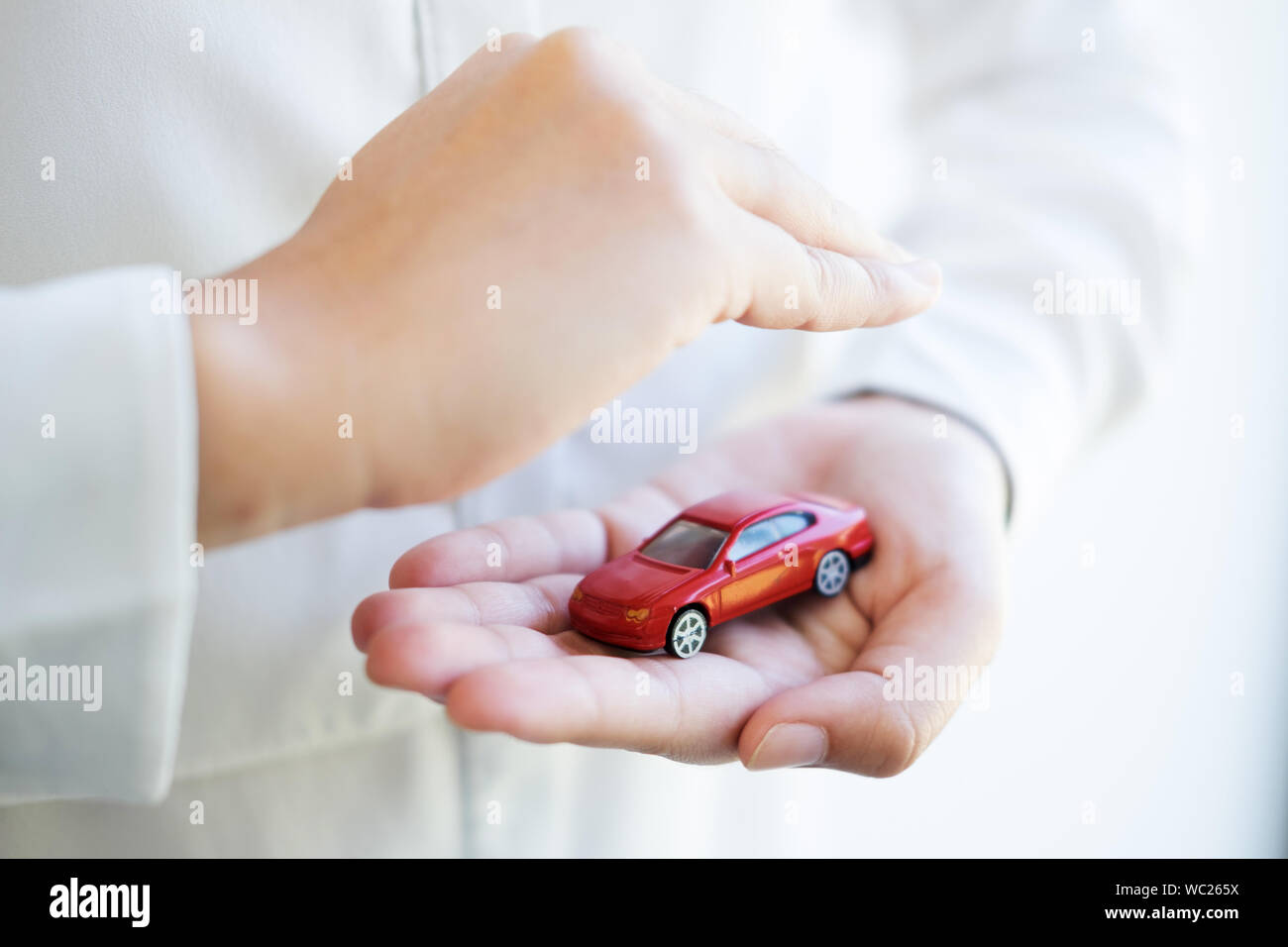 Human hand holding toy car hi-res stock photography and images - Alamy