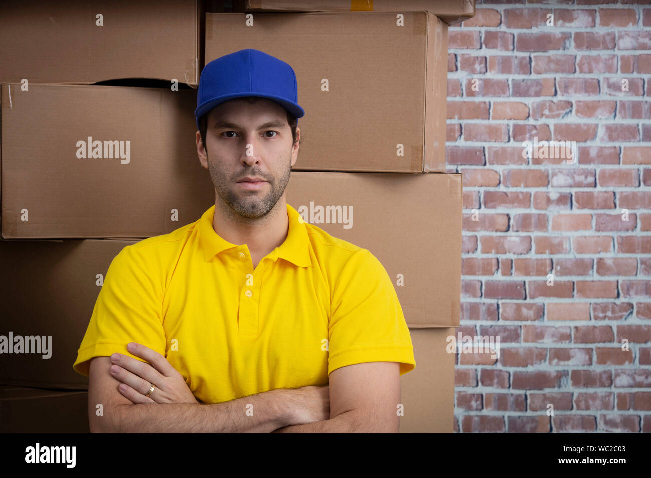 Man in work uniform arms crossed hi-res stock photography and images ...