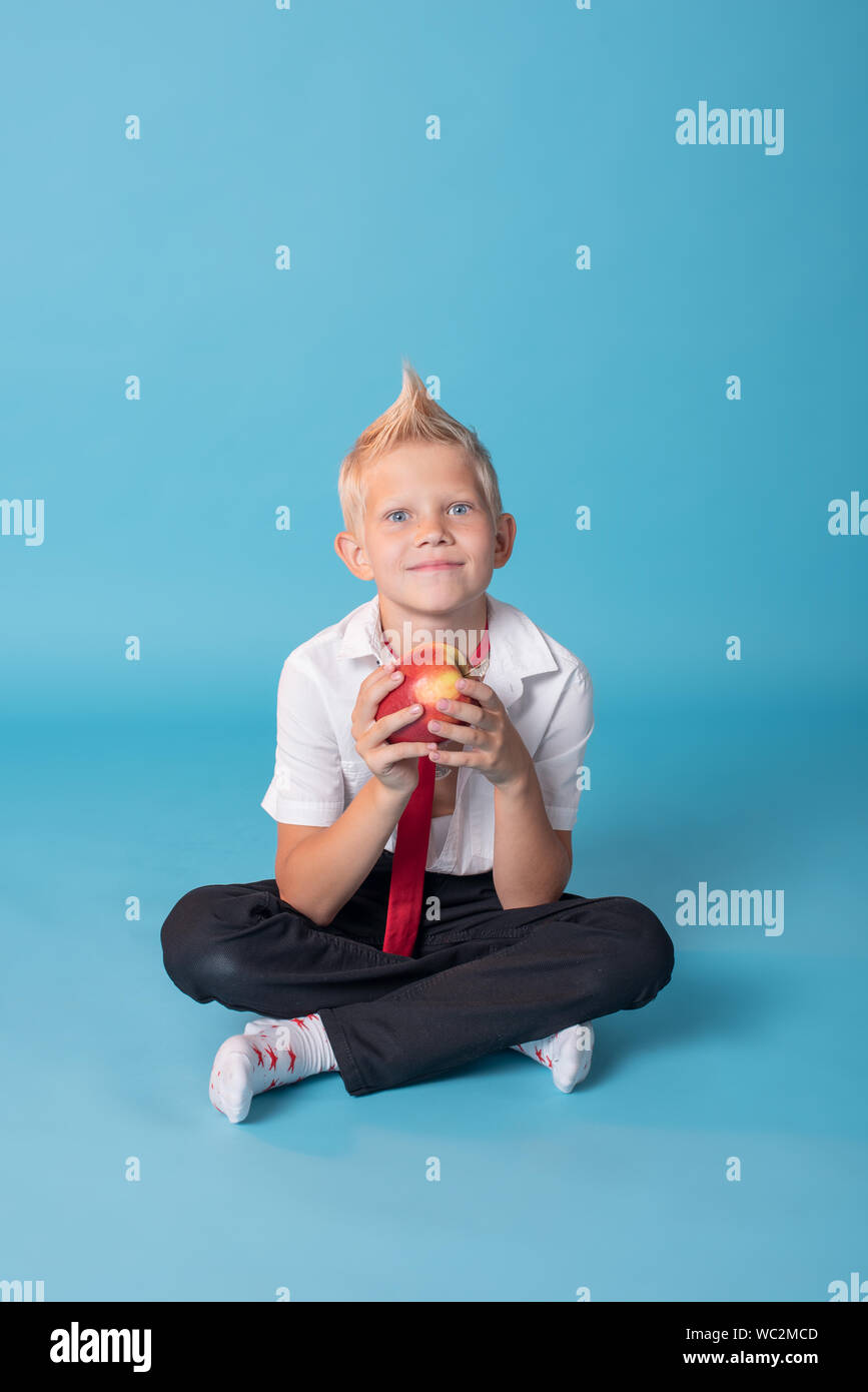 Close-up of a blond boy.The boy is posing on the camera. He is charming ...