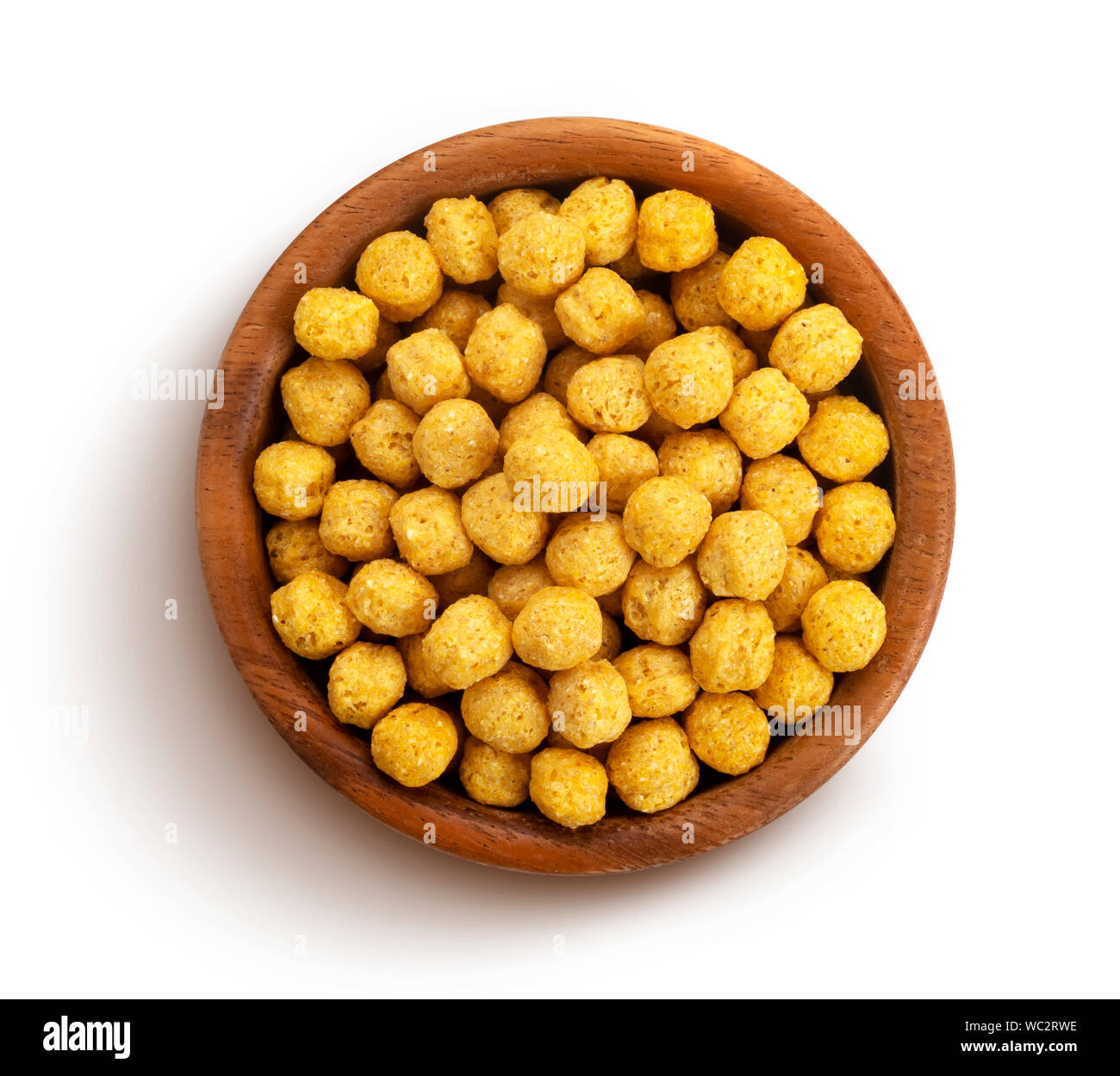 Wooden bowl of sweet corn balls flakes isolated on white background ...