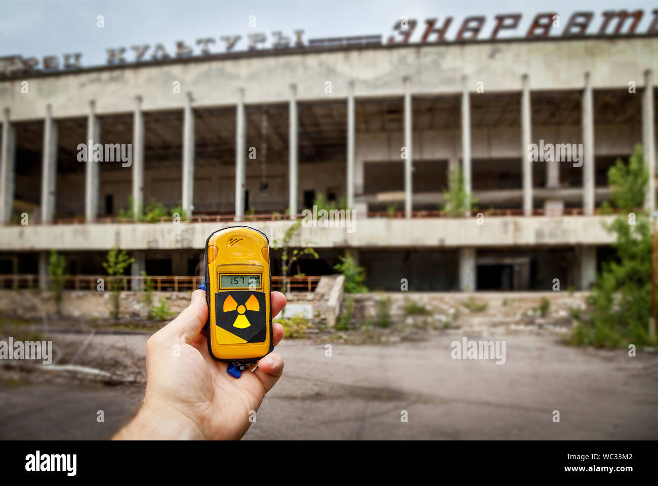 A dosimeter in hands with a level of radioactivity in the city of ...
