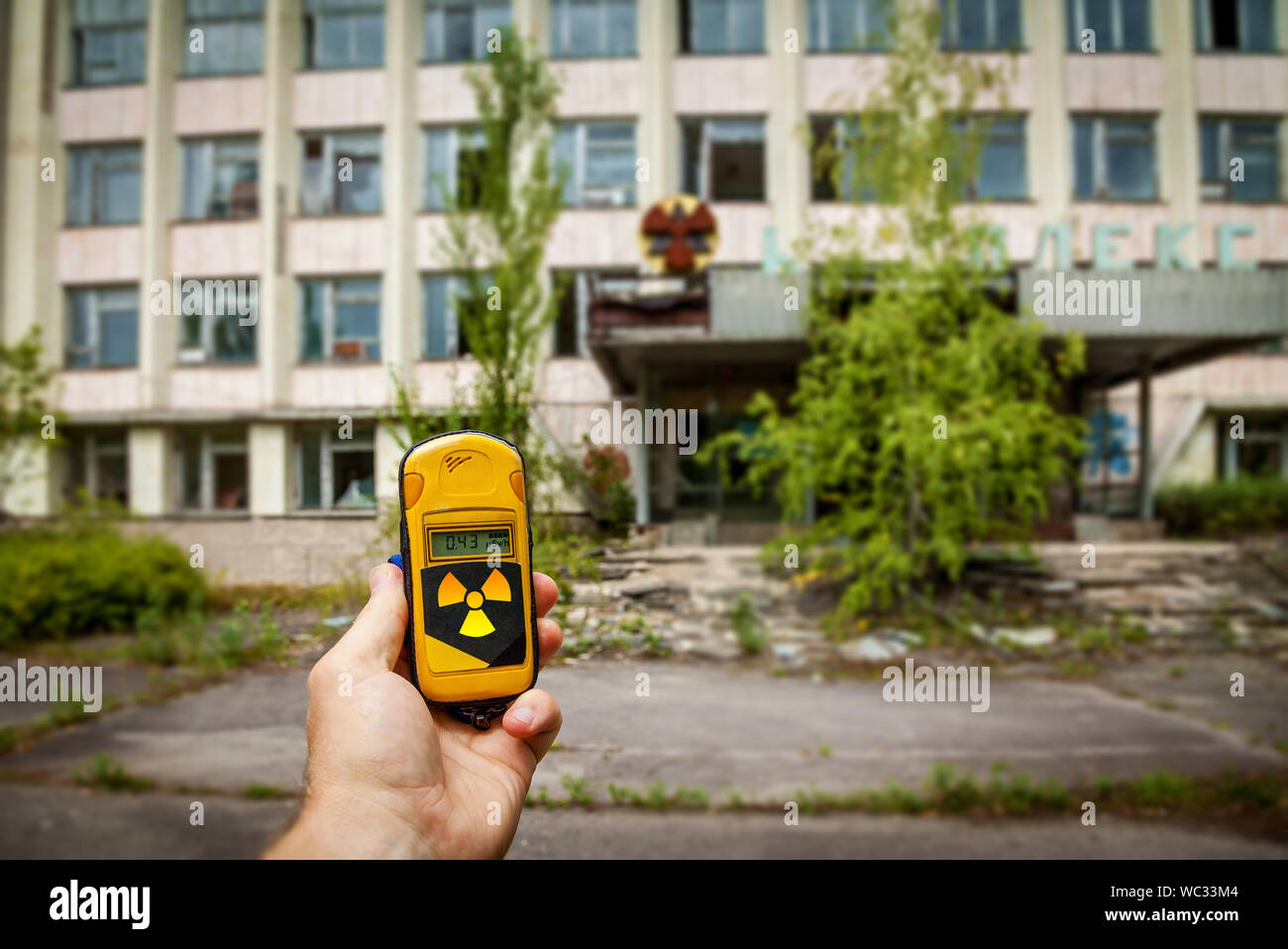 A dosimeter in hands with a level of radioactivity in the city of ...