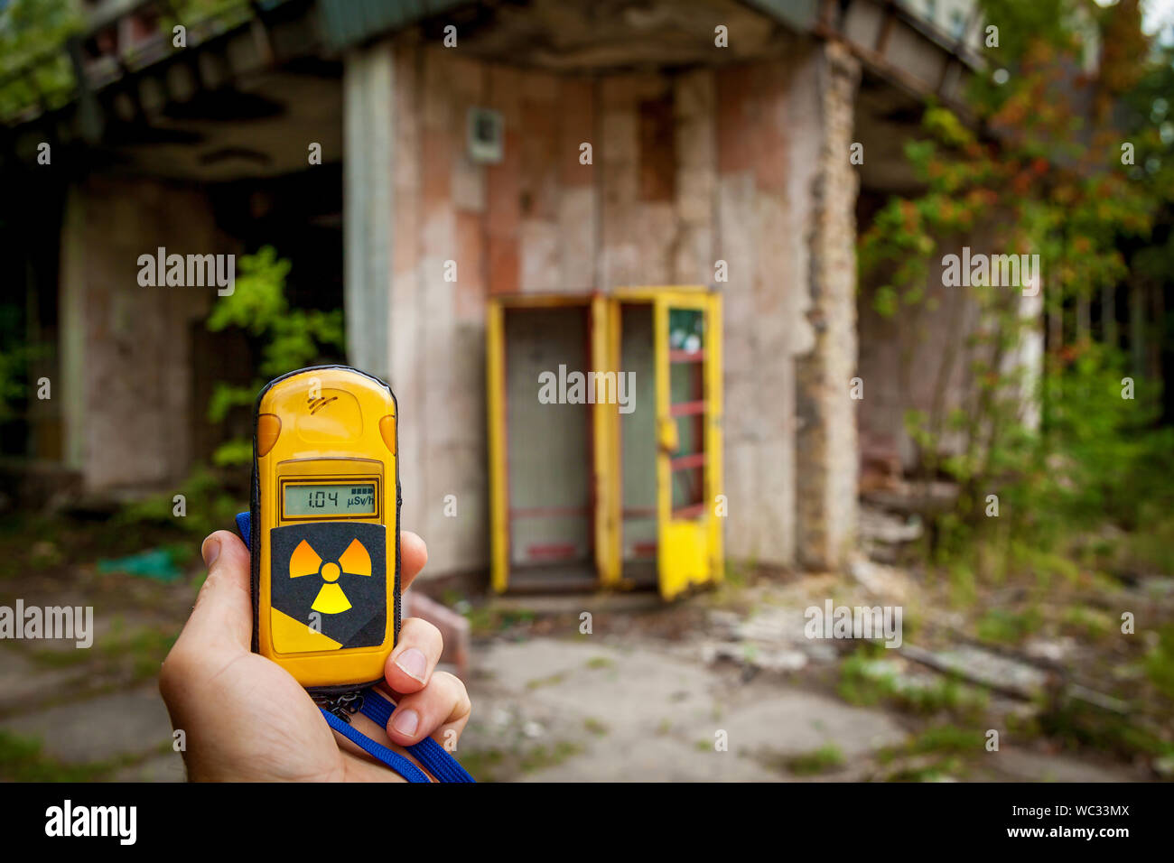 A dosimeter in hands with a level of radioactivity in the city of ...