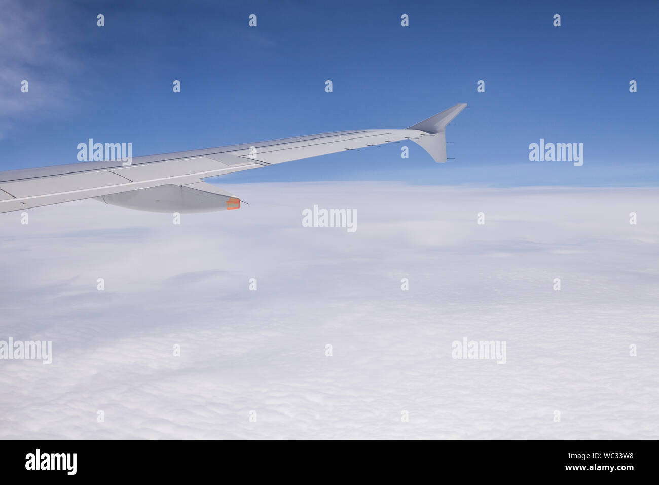 Commercial aircraft in flight above the clouds Stock Photo - Alamy