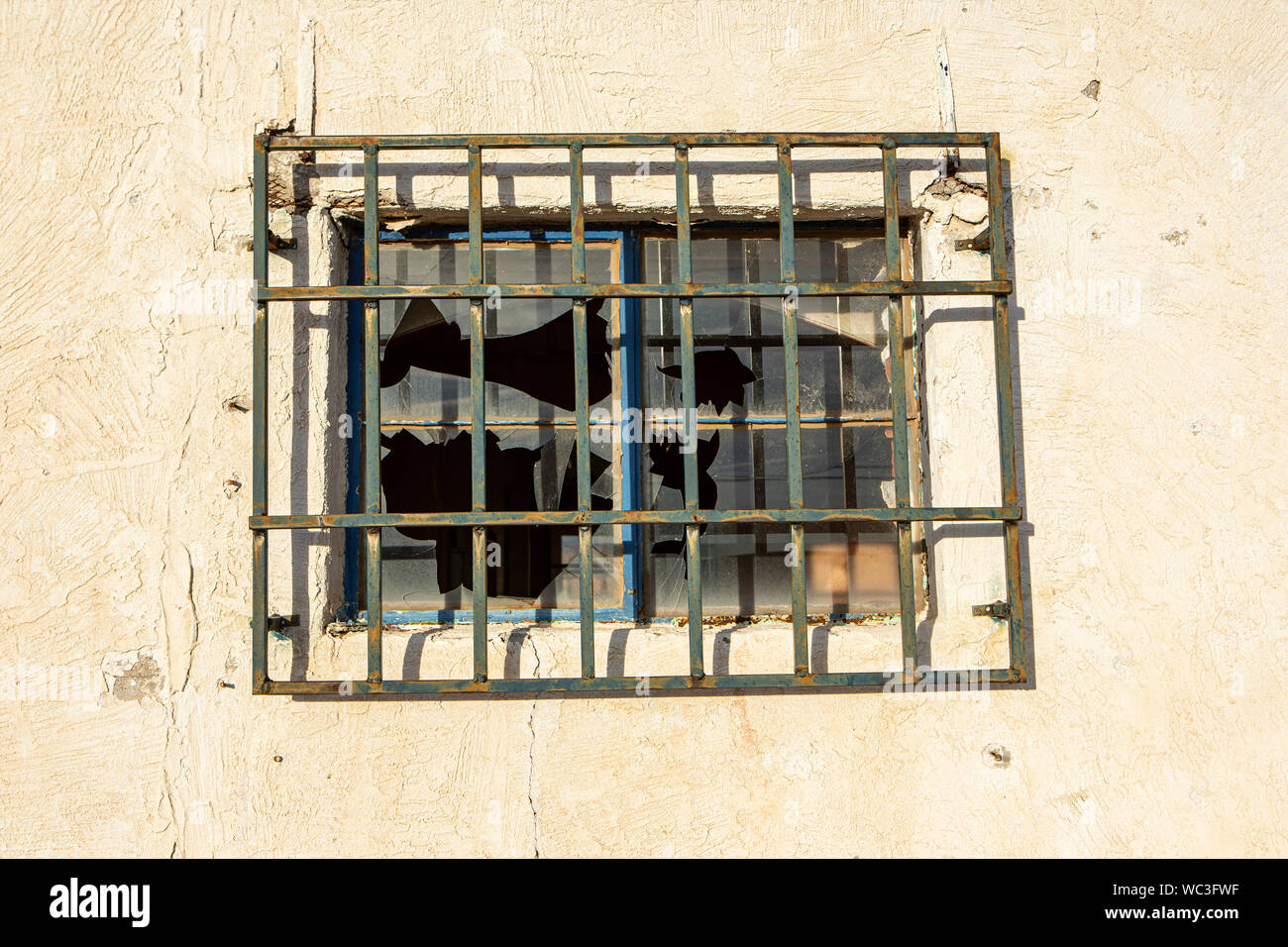 A barred broken window Stock Photo - Alamy