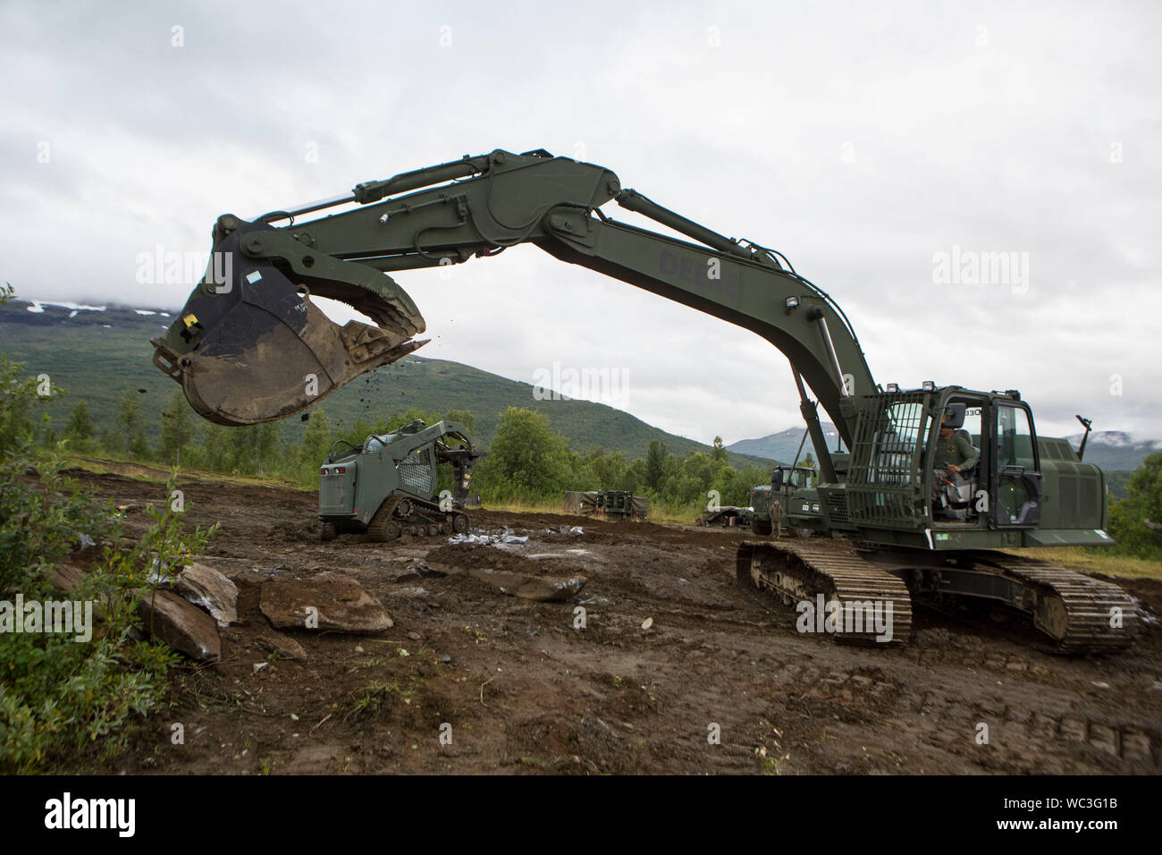 A U.S. Marine with II Marine Expeditionary Force, uses a hydraulic ...
