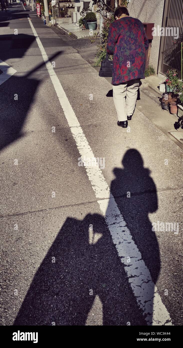 Two women walking behind him hi-res stock photography and images - Alamy