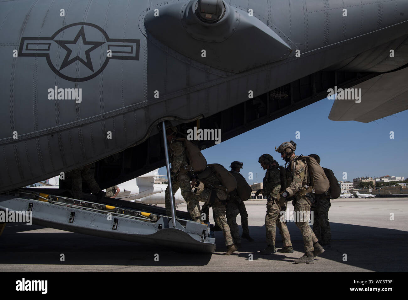 U.S. Air Force Special Tactics Operators load a C-130H3 Hercules to ...
