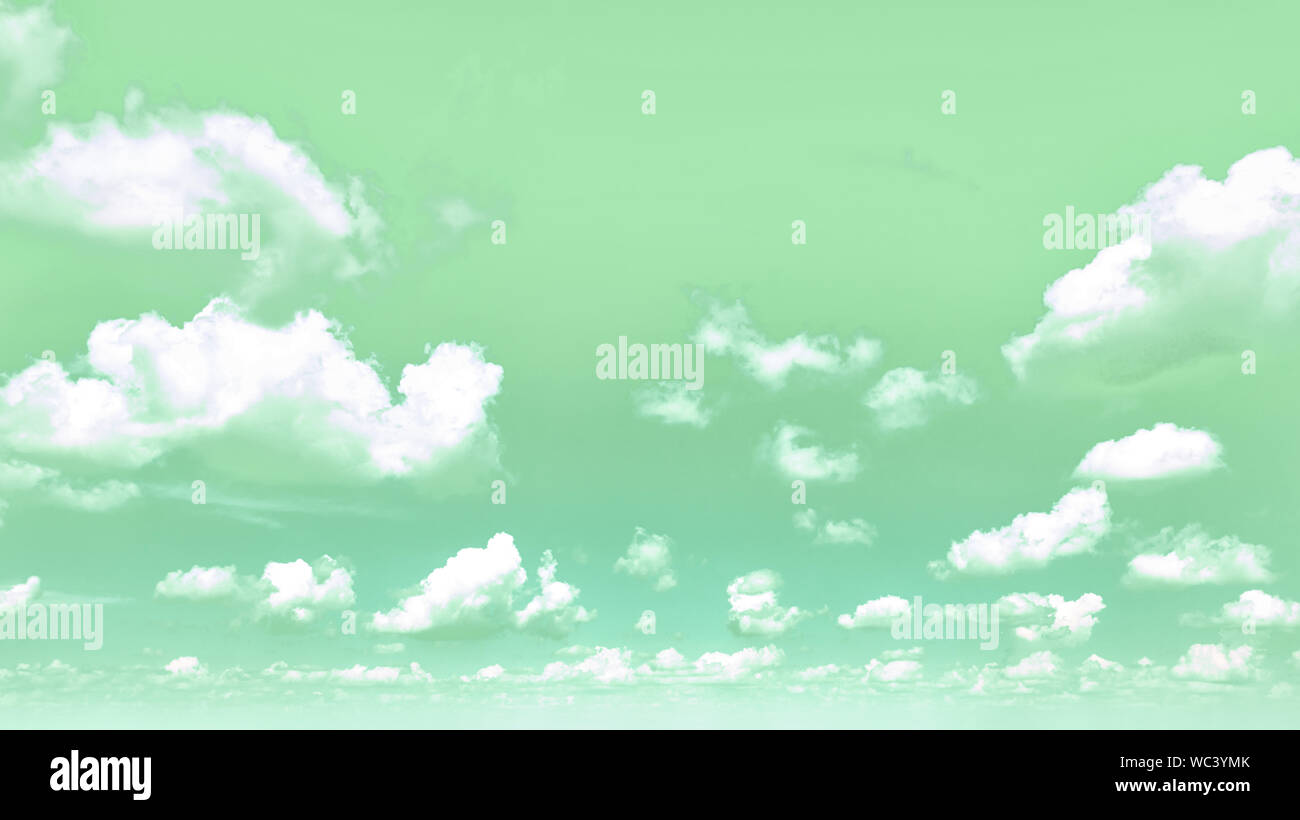 Beautiful mint colored sky background with sparced white clouds ...