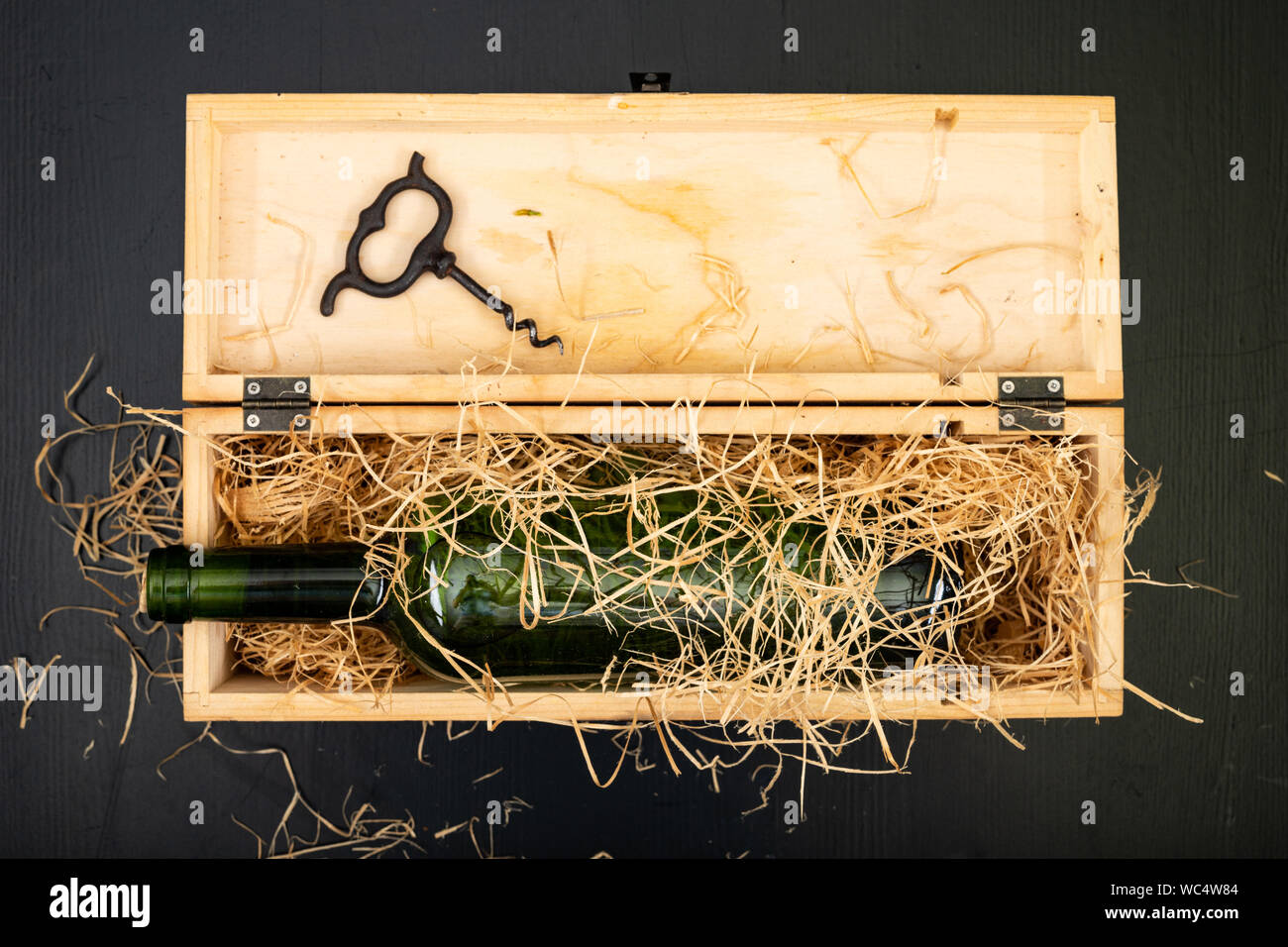 A bottle of wine in a wooden box. A tasty alcoholic drink in an elegant ...