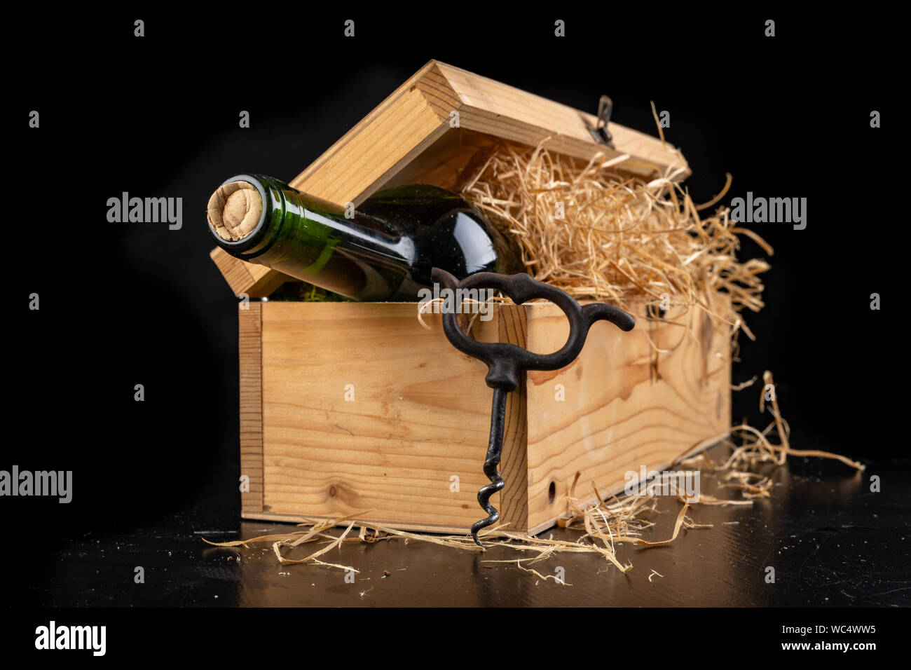 A bottle of wine in a wooden box. A tasty alcoholic drink in an elegant ...
