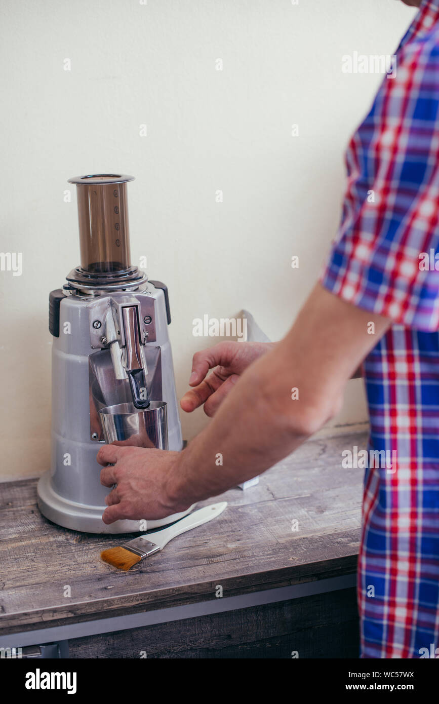 Expert barista close up hands preparing delicious coffee operating ...