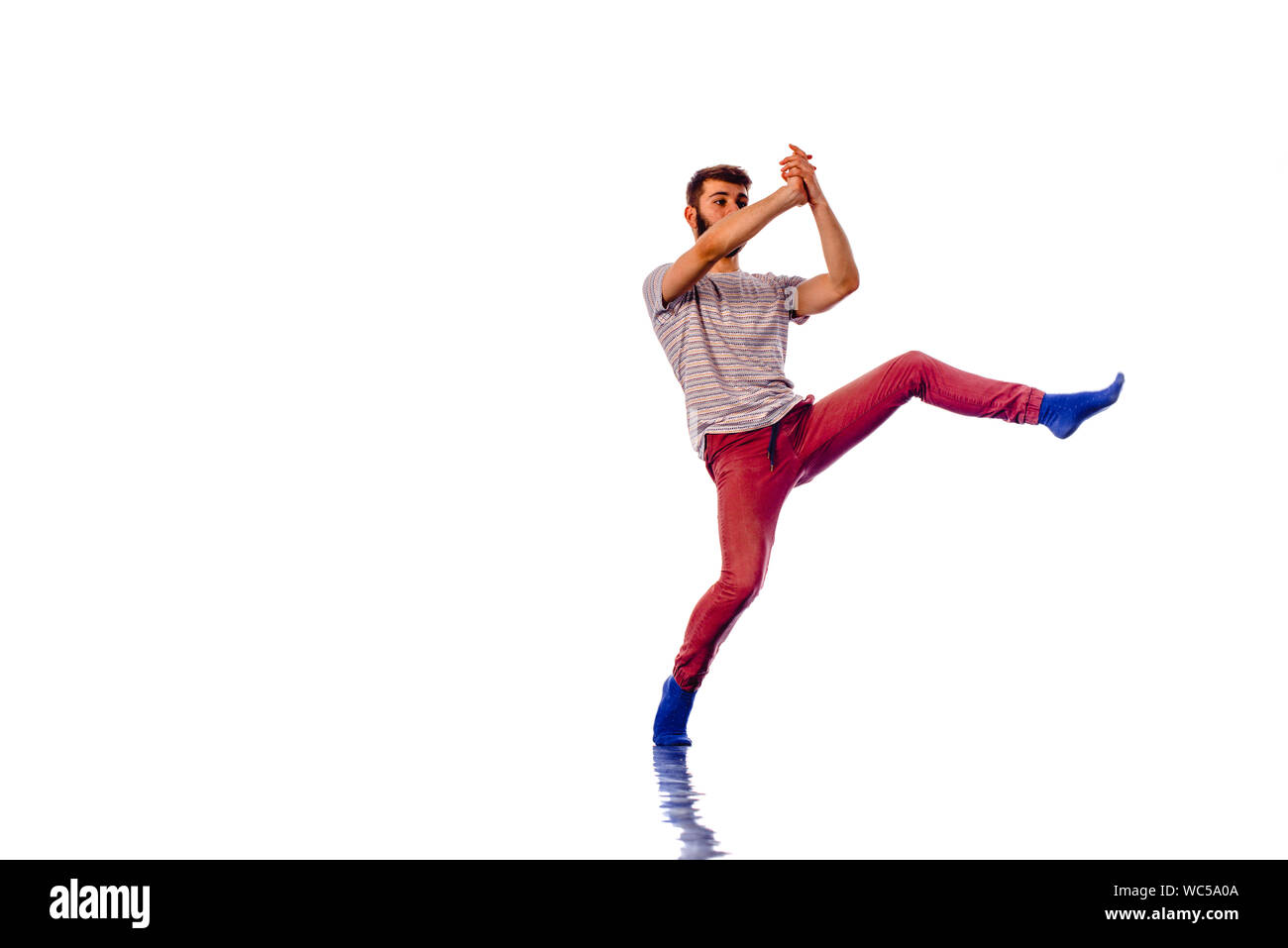 Acrobat is doing amazing dance on a white background Stock Photo - Alamy