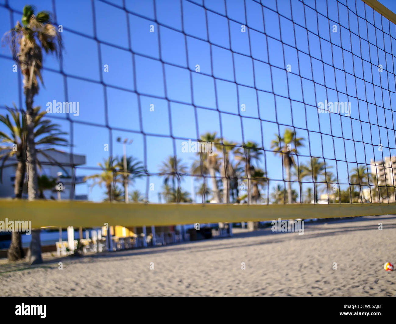Yellow volleyball net stretched on the beach, close-up Stock Photo - Alamy