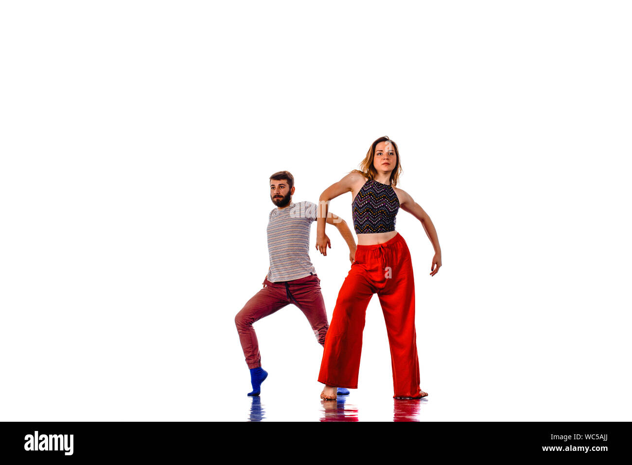 Romantic couple dancing together in studio, isolated on white ...