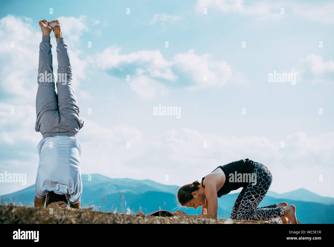 Couple in mountain pose practicing hi-res stock photography and images ...