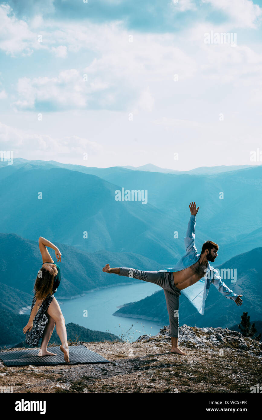 Romantic young loving couple dancing outdoors under blue sky at ...