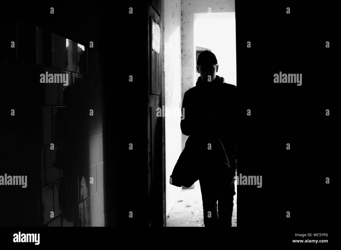 Silhouette man standing doorway Black and White Stock Photos & Images - Alamy