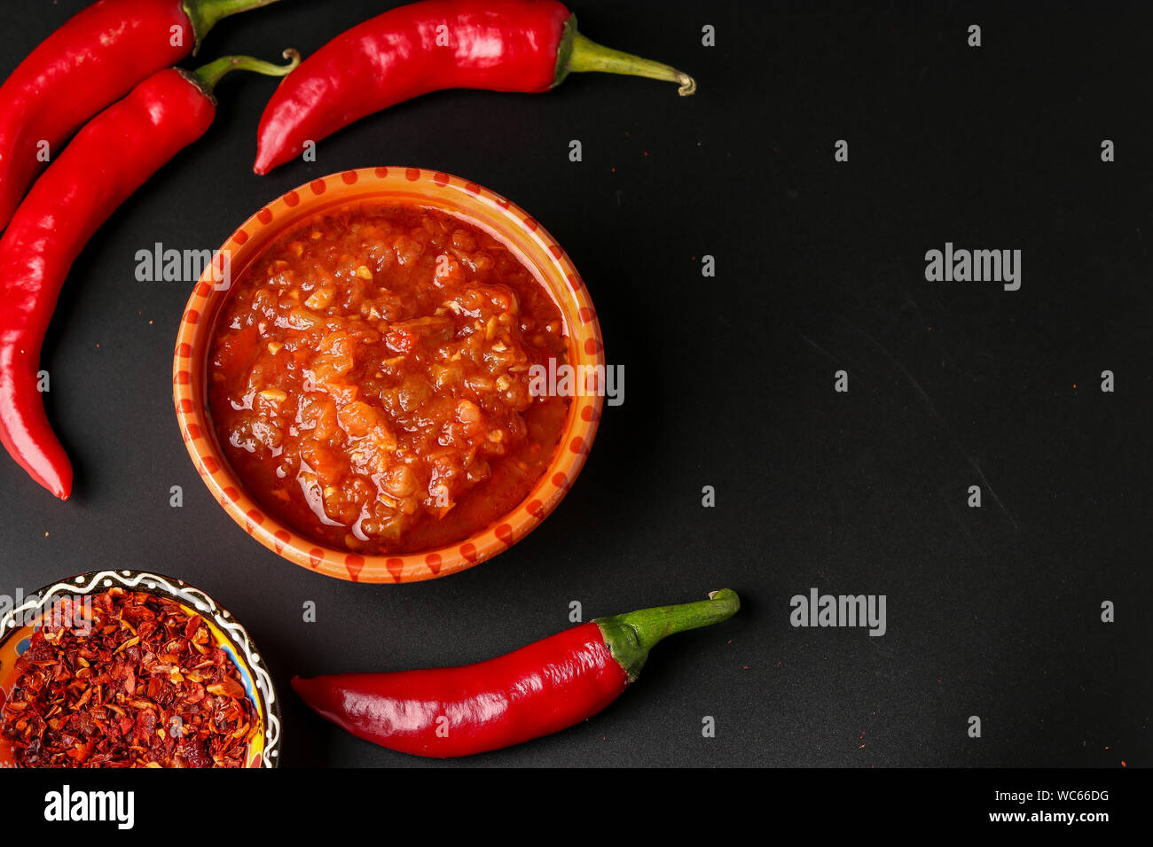 Traditional Maghrebi hot chili pepper sauce paste harissa on dark ...