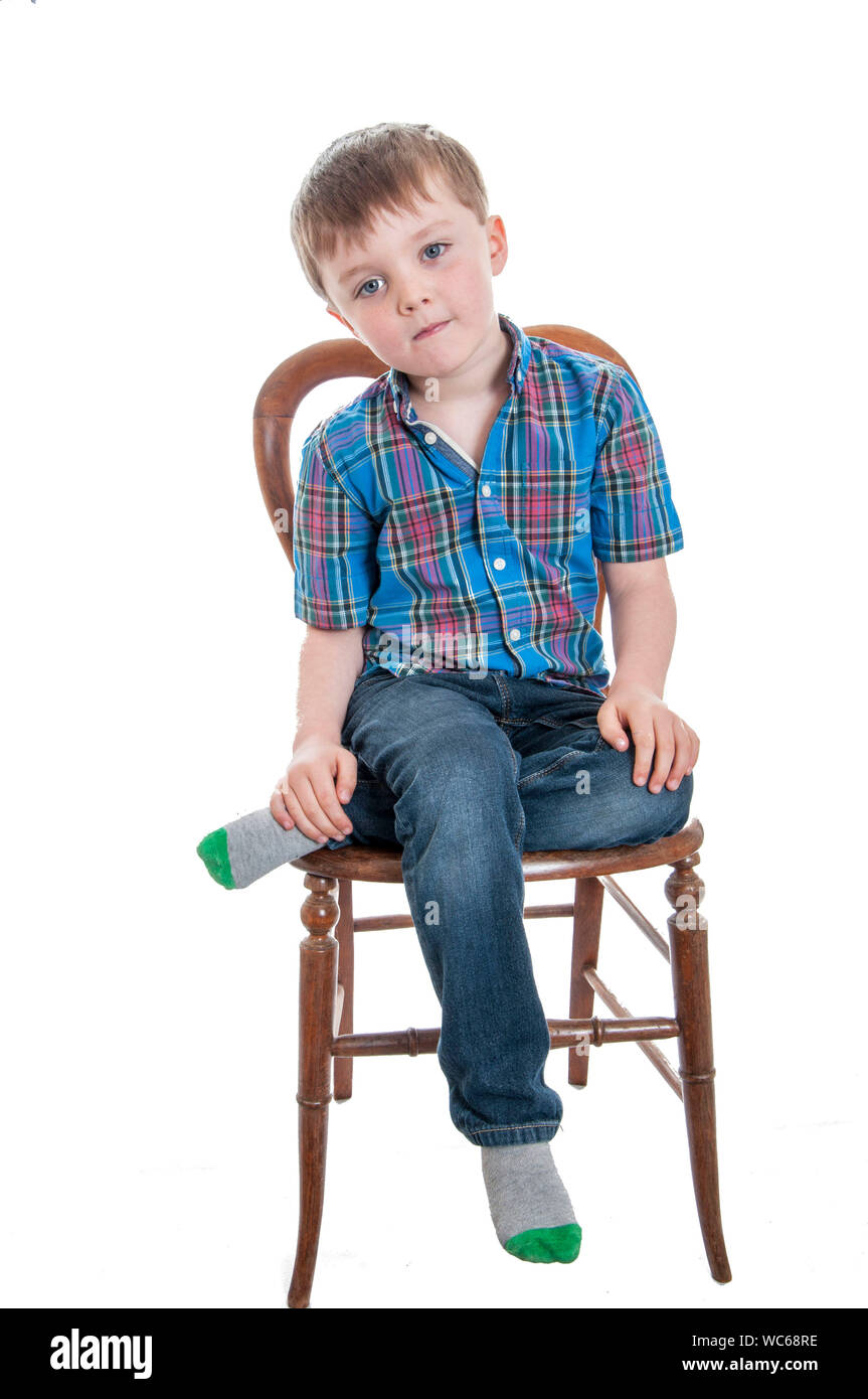 Boy on chair Cut Out Stock Images & Pictures - Alamy