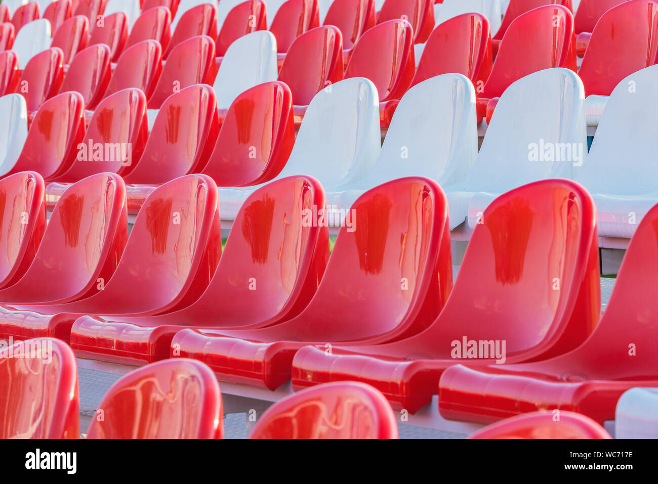 Red abd white empty seats on the tribune of the new stadium Stock Photo ...