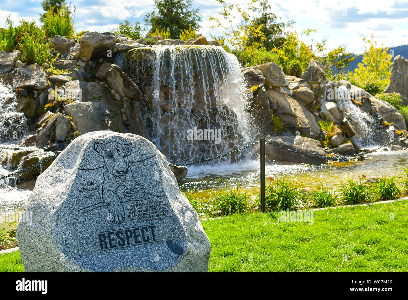 Waterfall and pond with granite stone in honor of fallen American ...