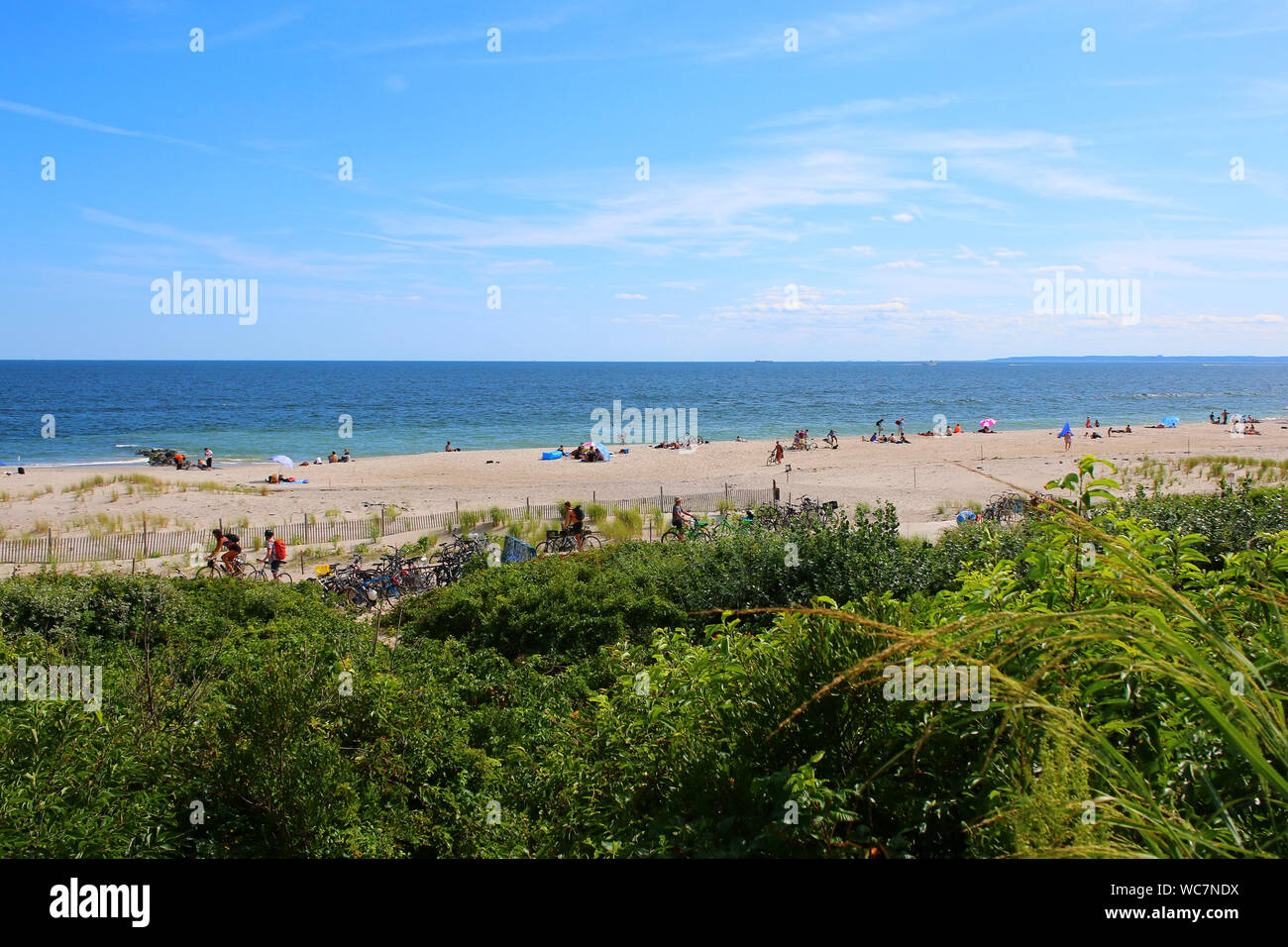People relaxing and sunbathing at the Fort Tilden beach on a hot summer ...