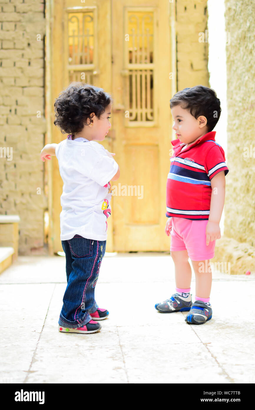 Two children standing hi-res stock photography and images - Alamy