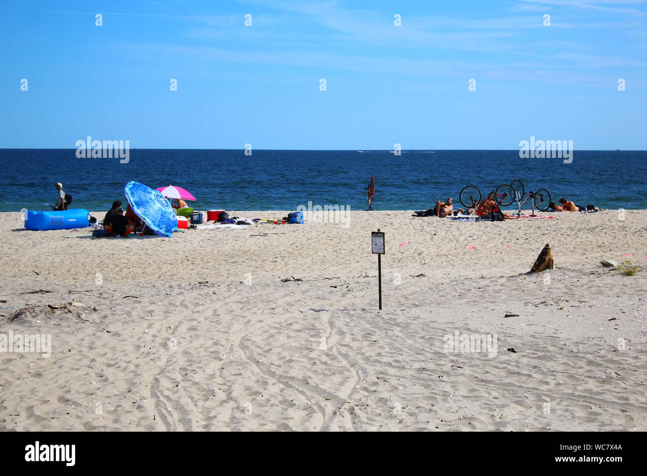People relaxing and sunbathing at the Fort Tilden beach on a hot summer ...
