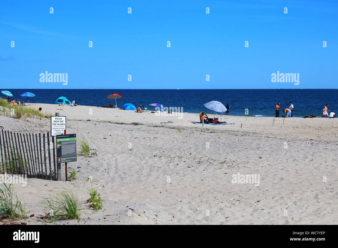 People relaxing and sunbathing at the Fort Tilden beach on a hot summer ...