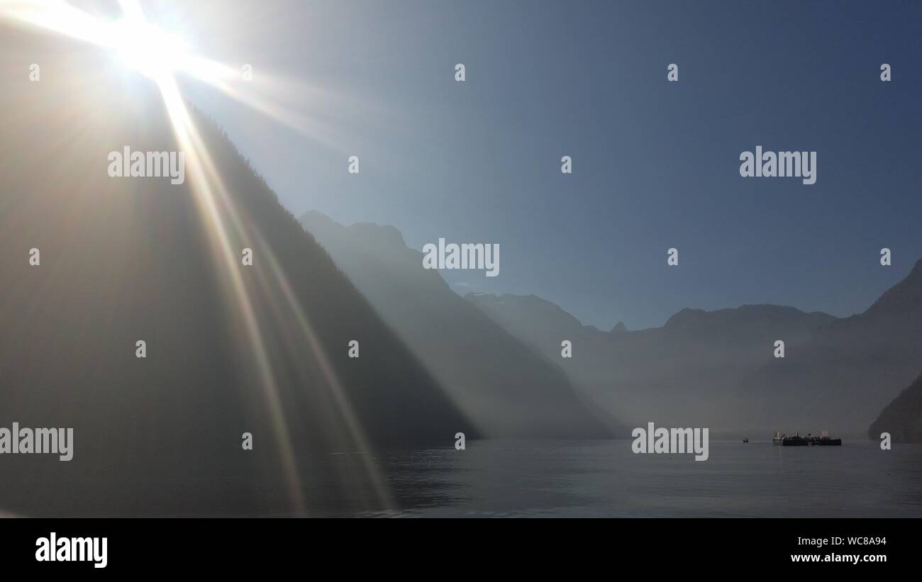 Sunlight streaming over mountains hi-res stock photography and images ...