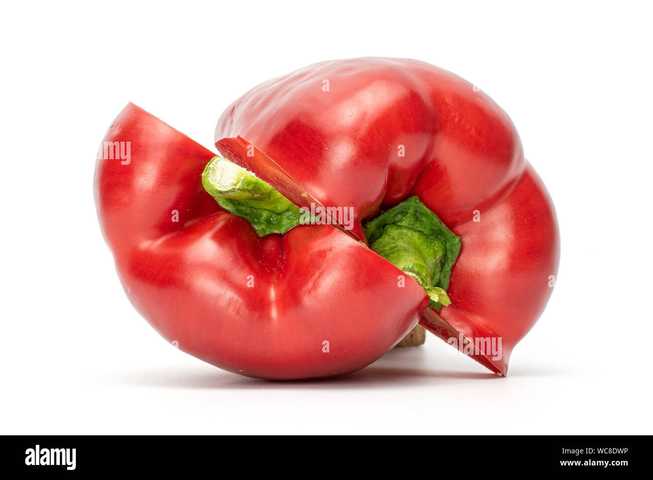 Group of two halves of red bell pepper one cut isolated on white ...