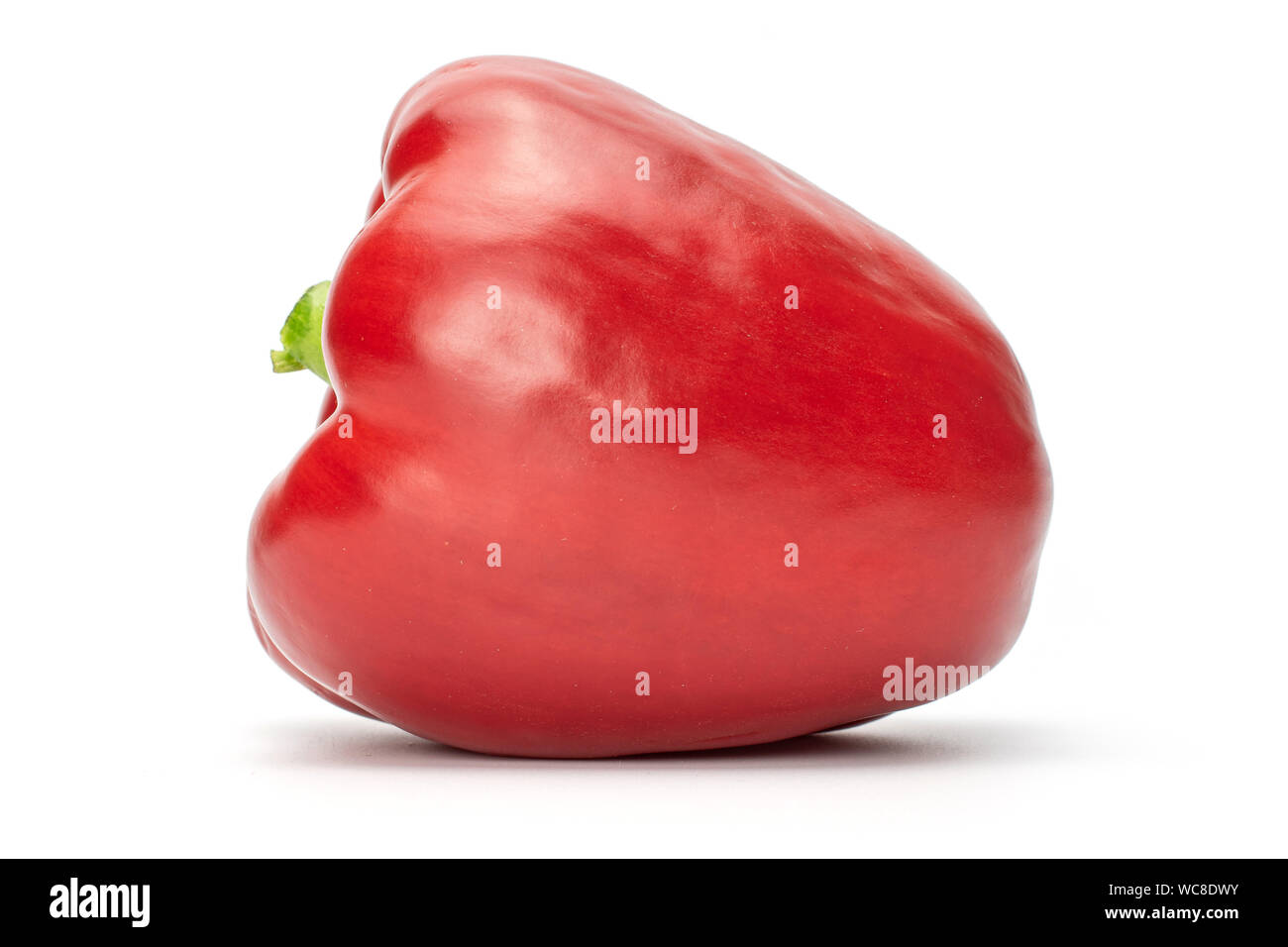 One whole glossy red bell pepper isolated on white background Stock ...
